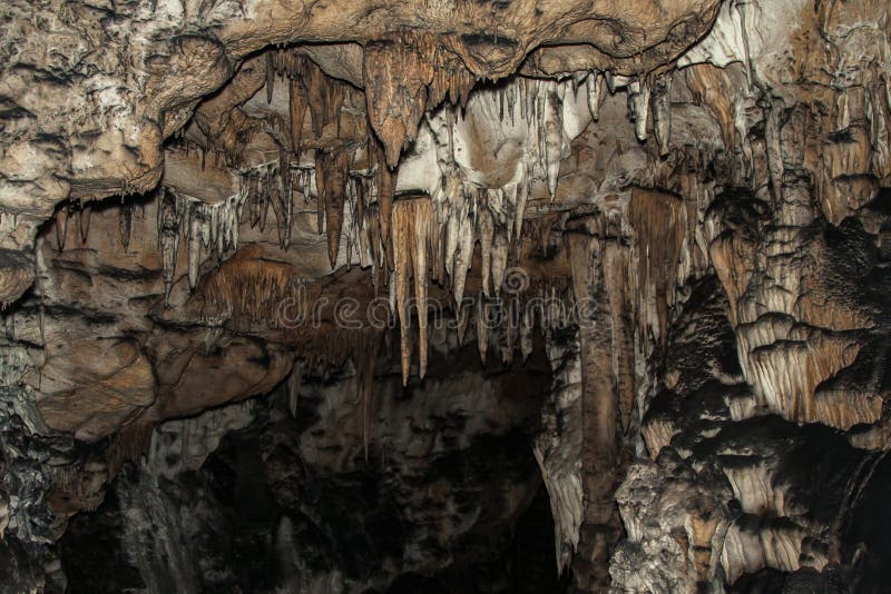 A Lot of Small Stalactites and One Big Stalagnate in a Limestone Cave ...