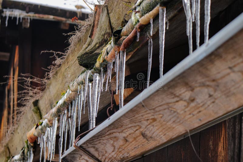 Stalactites of Ice Melting in a Roof Gutter Stock Photo - Image of ...