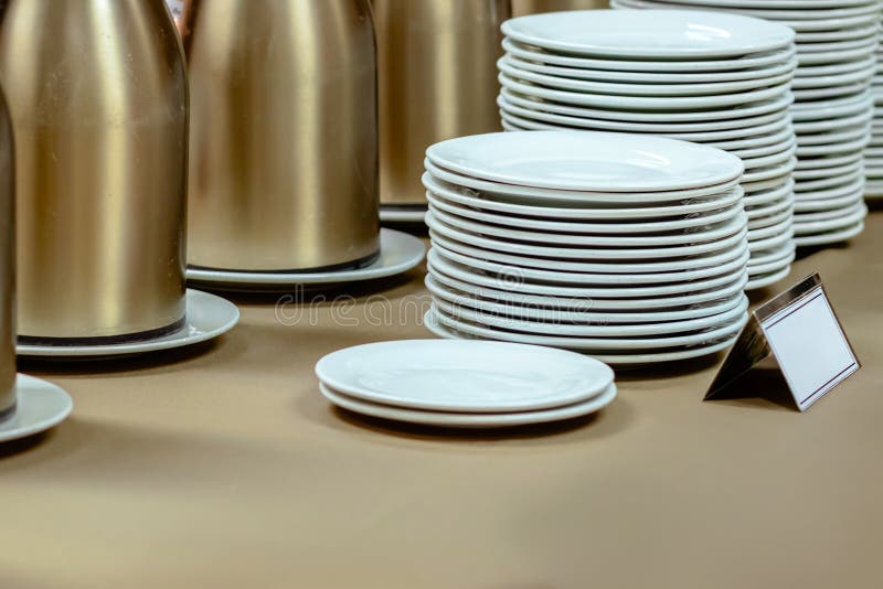 Stalks of Plain White Plates on Top of Buffet Table. Stack of White ...