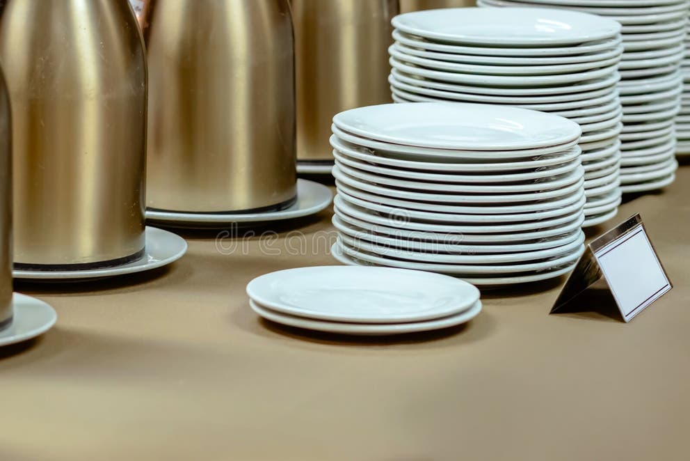 Stalks of Plain White Plates on Top of Buffet Table. Stack of White ...