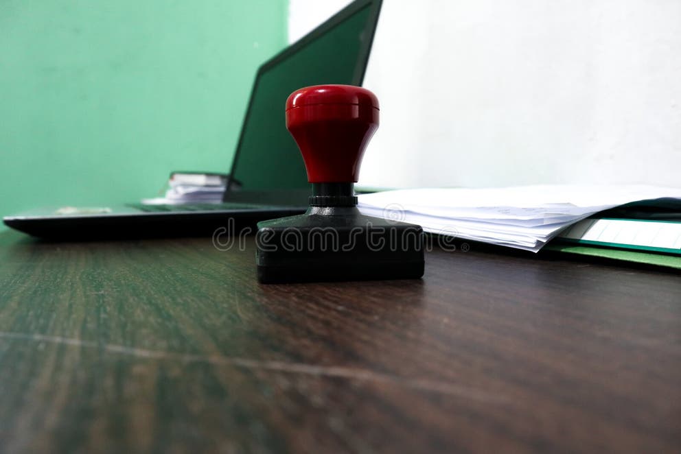 Stamp with Red Handle on Table Stock Photo - Image of black, stamp ...