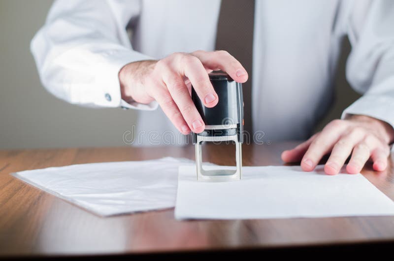 Stamp a seal on the table stock photo. Image of paper - 104397338