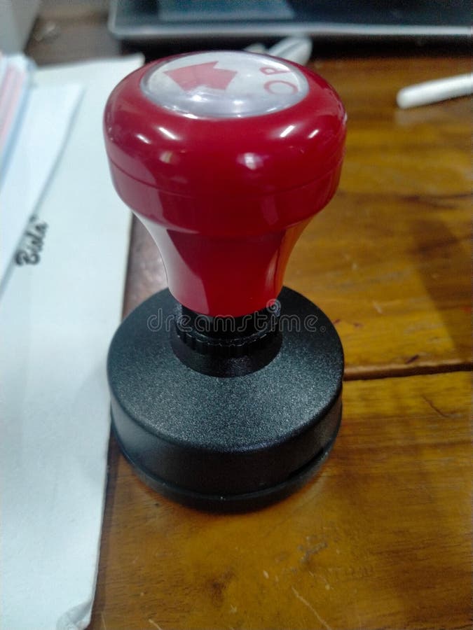 A Stample in the Shape of a Circle with a Red Body on Top and Black on ...