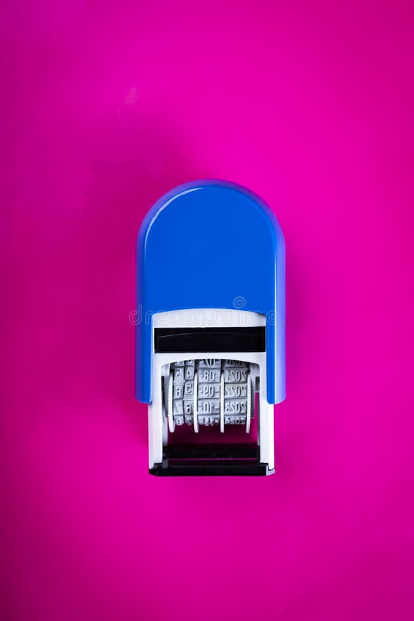 Automatic Date Stamp .Modern Plastic Date Stamps on a Pink Background ...