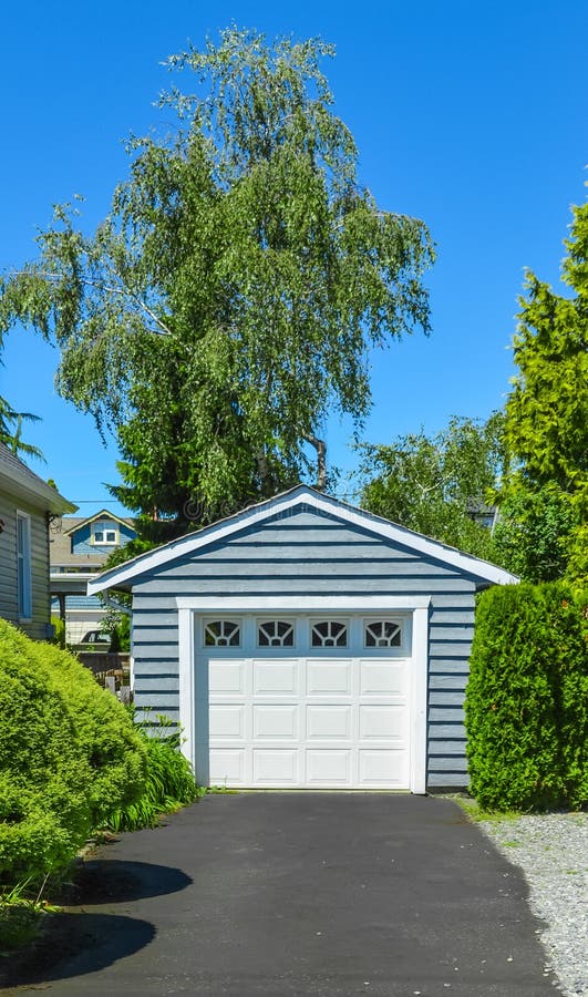 Stand Along Single Garage on a Back Yard with Asphalt Driveway. Stock ...