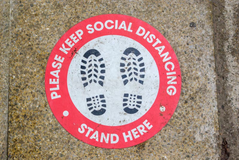 STAND HERE Floor Sticker on a Pavement Stock Image - Image of ...
