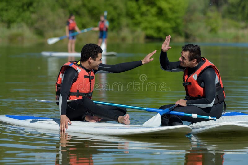 Stand Up Paddle Friends Having Fun Imagen de archivo - Imagen de ...