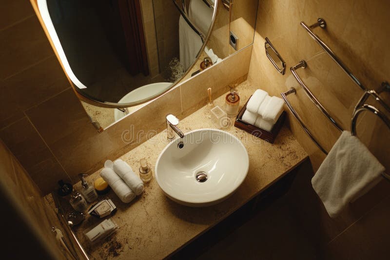 A Standard Bathroom Setup Featuring a Sink, Mirror, and Toilet Stock ...