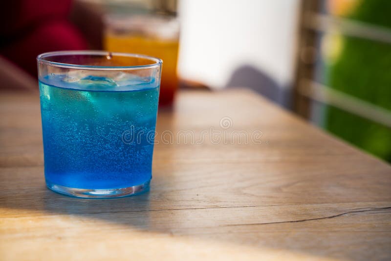 Standard Blue Lagoon Cocktail on Light Grey Table with Ice Cube and ...