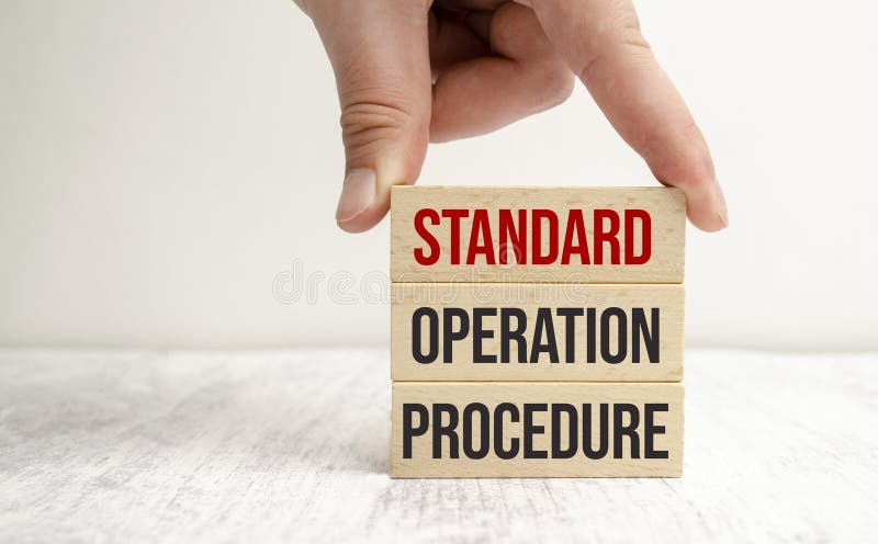 Standard Operation Procedure Words on Wooden Blocks and Hand Stock ...