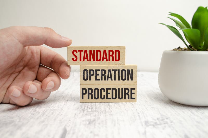 Standard Operation Procedure Words on Wooden Blocks and Hand Stock ...
