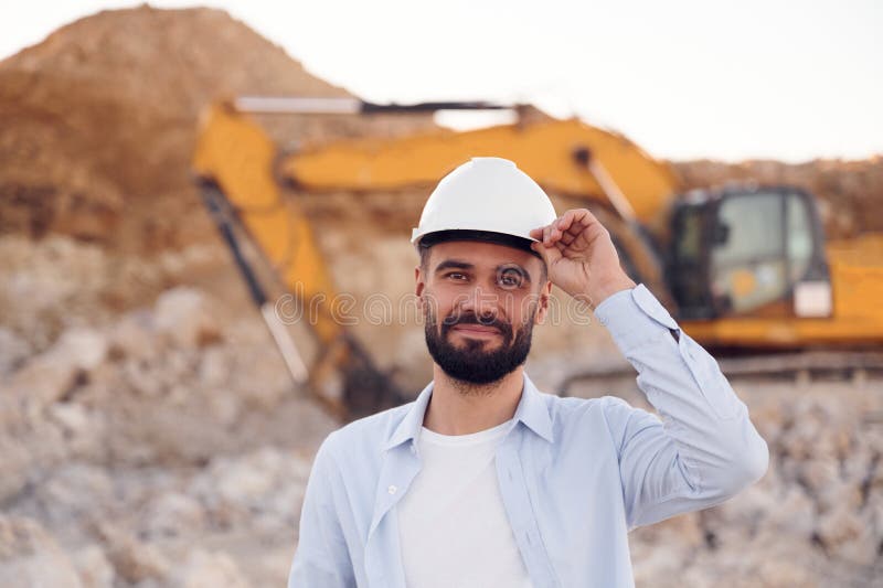 Standing Against Excavator. Man in Uniform is Working in the Quarry at ...