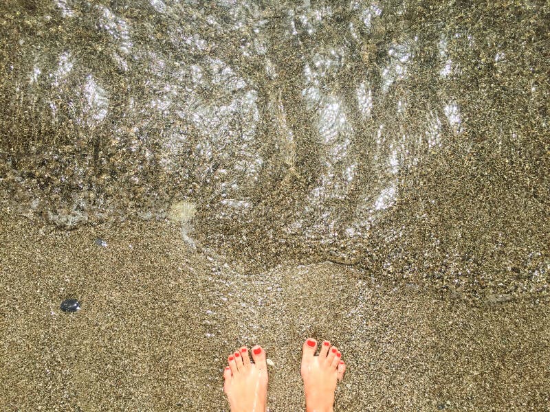 Standing on pebble beach stock photo. Image of coastal - 128248376