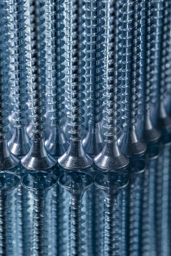 Standing Galvanized Self-tapping Screws on a Mirror Surface Stock Image ...