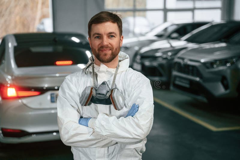 Standing in the Garage with Cars. Portrait of Professional Painter with ...
