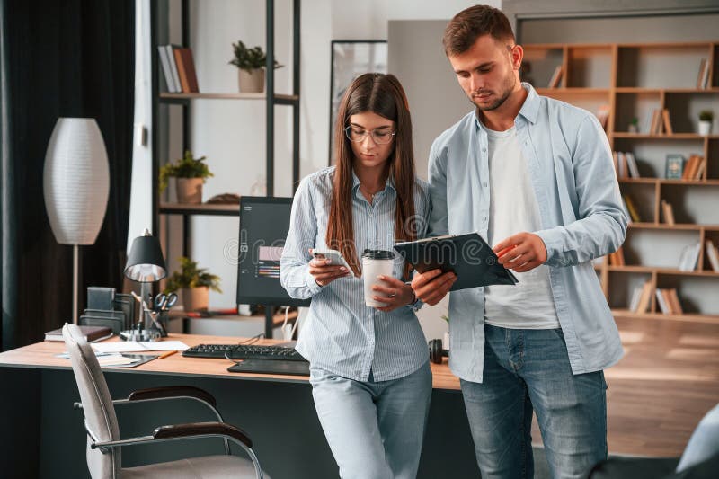 Standing and Holding Notepad. Two Young Designers is Working Together ...