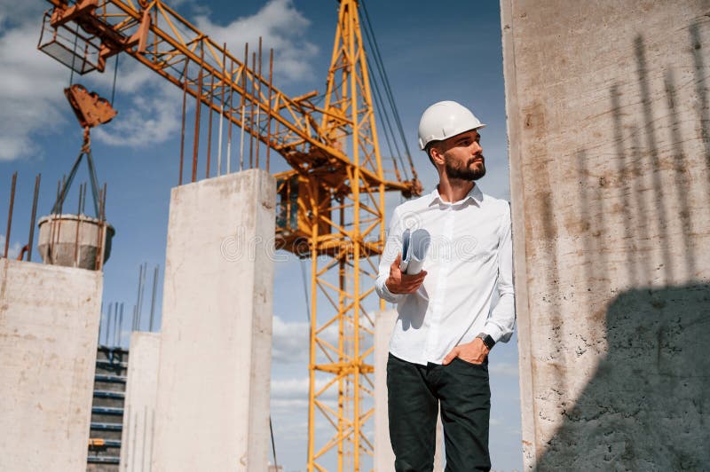 Standing and Holding Plan in Hands. Man in Uniform is Working on the ...