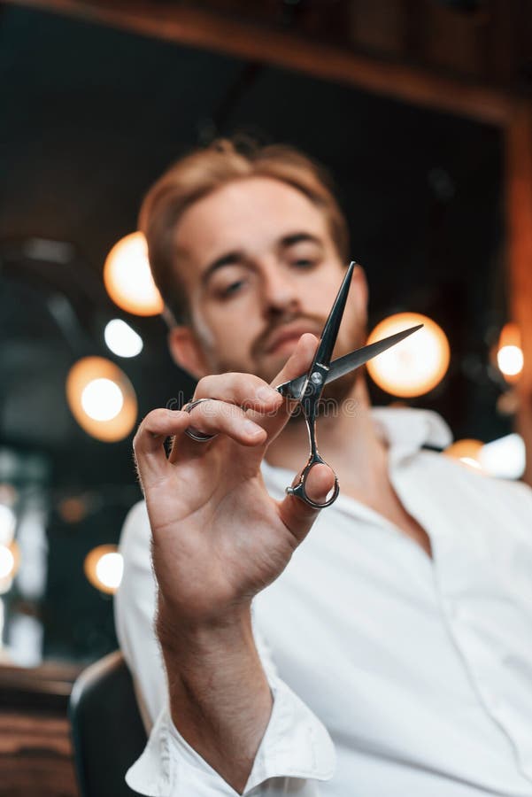 Standing and Holding Scissors. Handsome Barber is in the Salon Stock ...