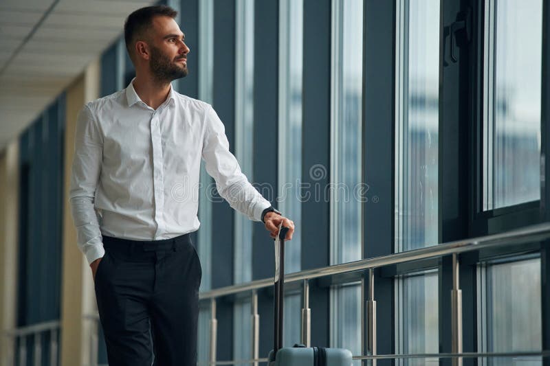 Standing, Looking through the Windows. Young Handsome Man in the ...