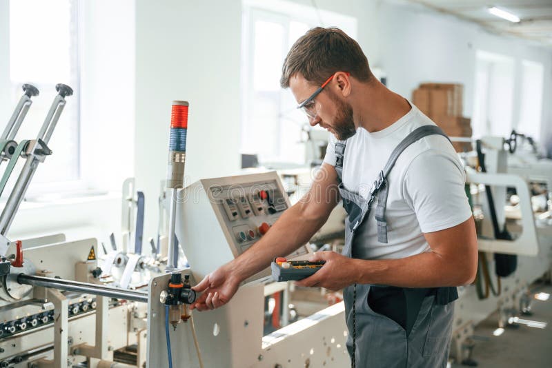 Standing by the Machine. Handsome Man is Working at the Factory of ...