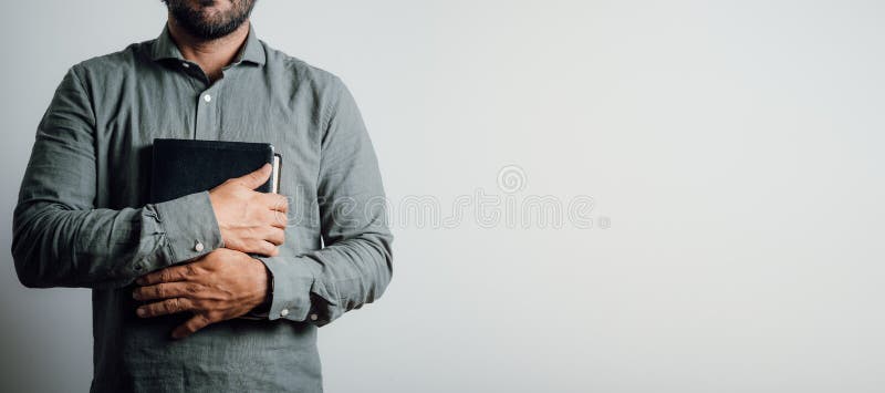 Standing Man Holding and Hugging the Bible on His Chest Stock Image ...