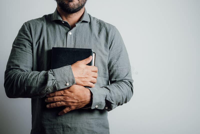Standing Man Holding and Hugging the Bible on His Chest Stock Image ...