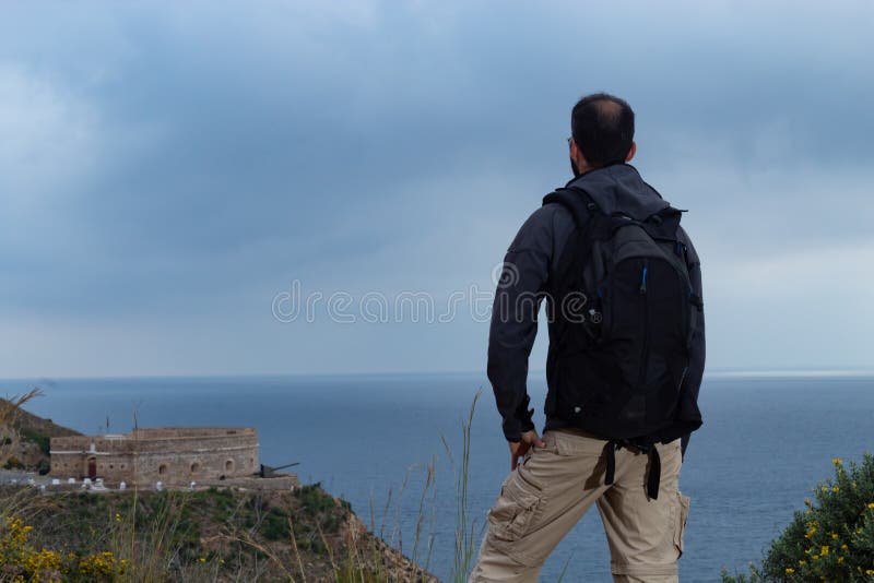 Man Standing On Rock Looking Into Distance Stock Photo - Image of ...