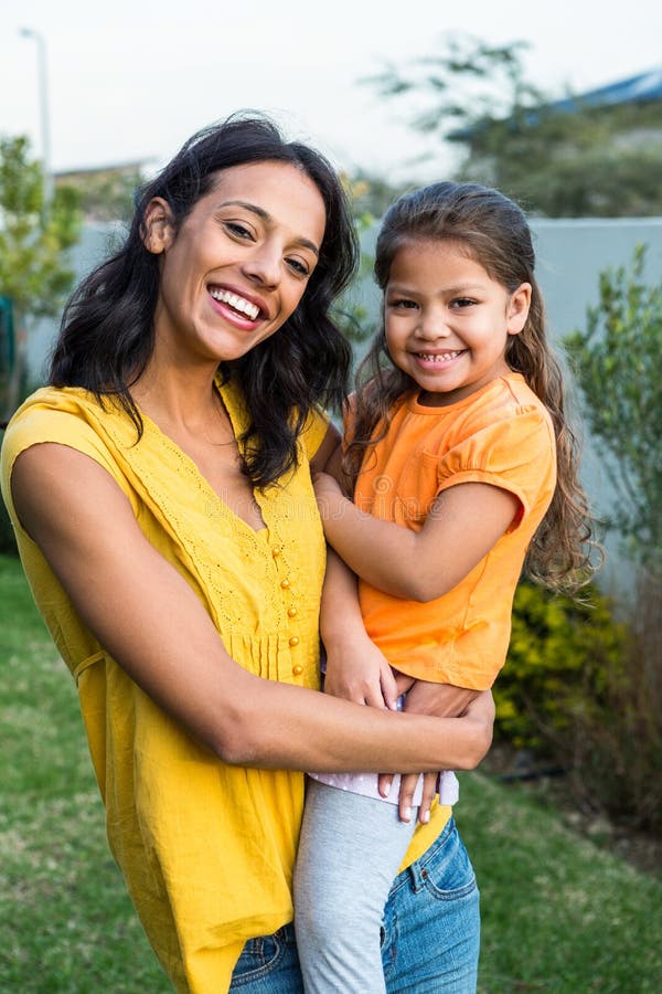 Standing Mother Holding Her Daughter Outdoors Stock Photo - Image of ...