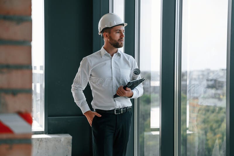 Standing Near Panoramic Windows. Man in White Shirt is Working Indoors ...