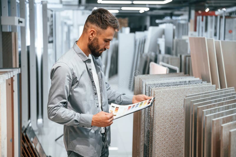 Standing with Notepad in Hands. Stylish Beautiul Man is in the Store of ...