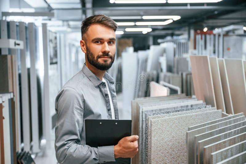 Standing with Notepad in Hands. Stylish Beautiul Man is in the Store of ...