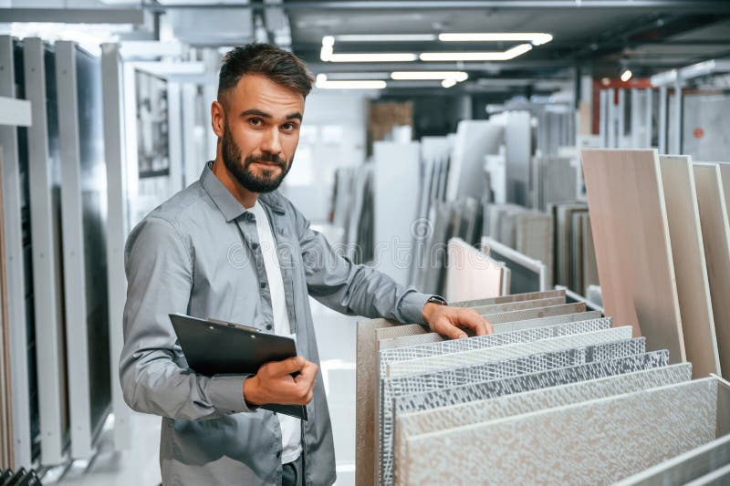 Standing with Notepad in Hands. Stylish Beautiul Man is in the Store of ...