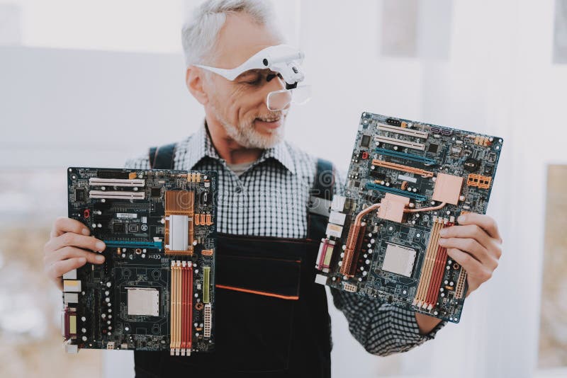 Standing Old Worker with Motherboards in Hands Stock Photo - Image of ...