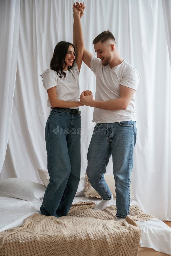 Standing and Playing on the Bed. Young Couple are Together at Home ...