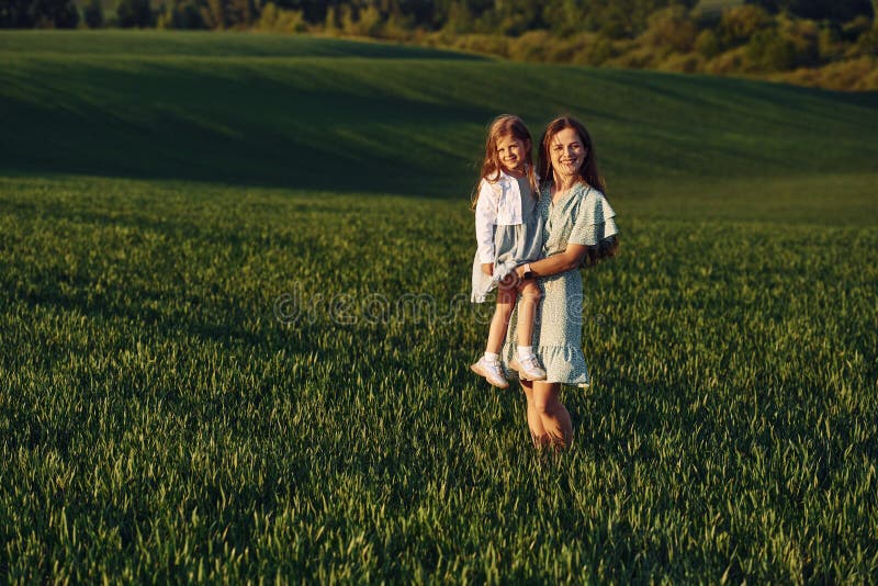 Standing and Posing for a Camera. Mother and Daughter Have Fun Outdoors ...