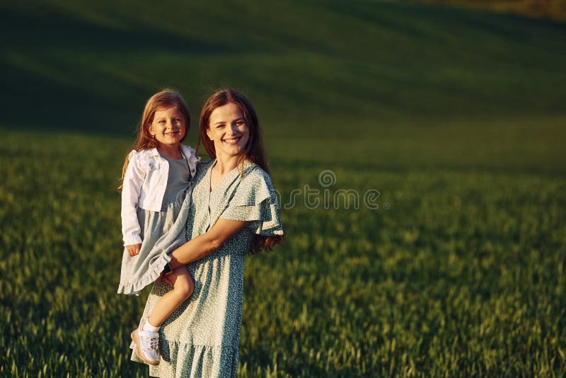 Standing and Posing for a Camera. Mother and Daughter Have Fun Outdoors ...