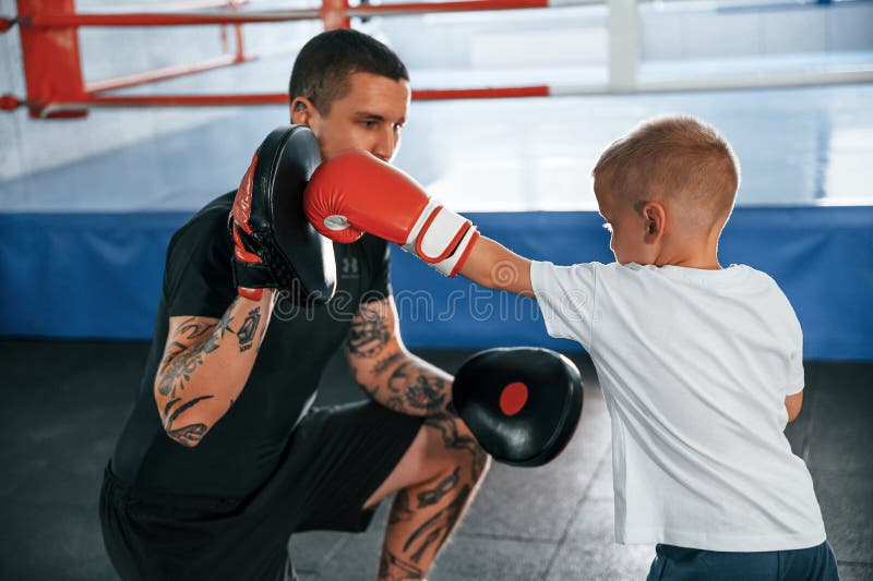 Standing and Practicing the Punches. Coach is Teaching the Boy Box ...