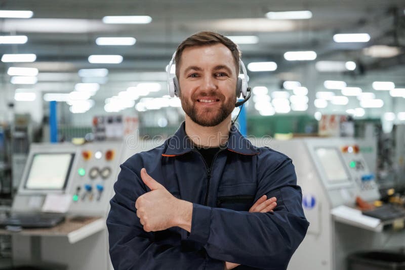 Standing and Smiling. Factory Worker is Indoors with Hard Hat Stock ...