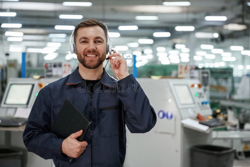 Standing and Smiling. Factory Worker is Indoors with Hard Hat Stock ...