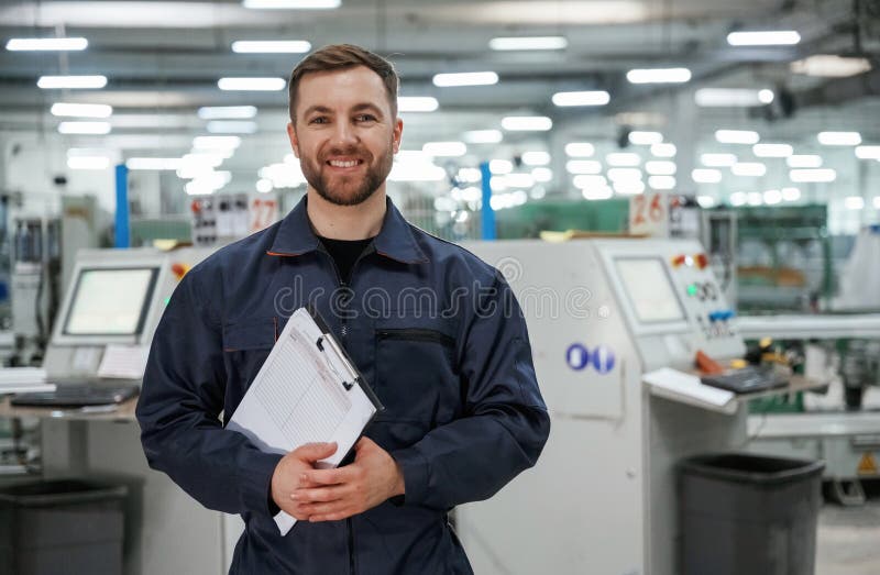 Standing and Smiling. Factory Worker is Indoors with Hard Hat Stock ...