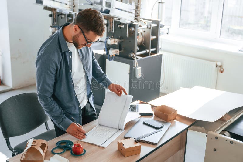 Standing by the Table. Handsome Man is Working at the Factory of ...