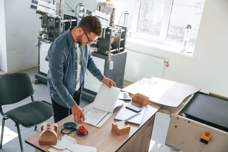 Standing by the Table. Handsome Man is Working at the Factory of ...