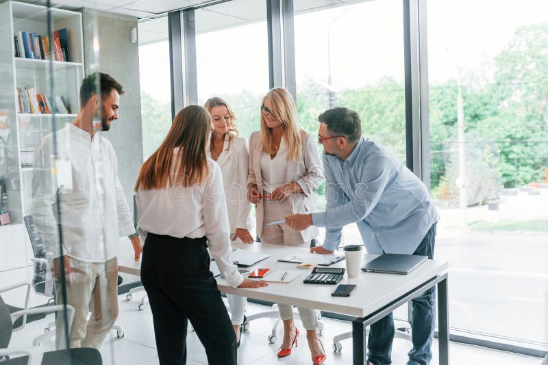 Standing by the Table Near Big Windows. Group of Professional Business ...