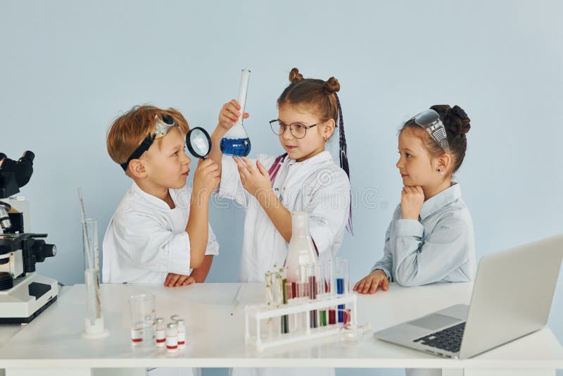 Standing by the Table with Test Tubes. Children in White Coats Plays a ...