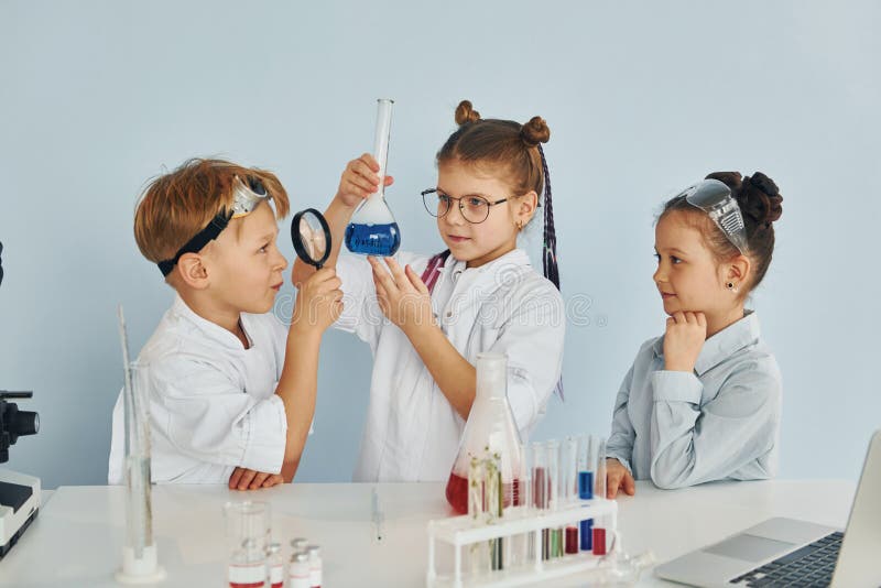 Standing by the Table with Test Tubes. Children in White Coats Plays a ...
