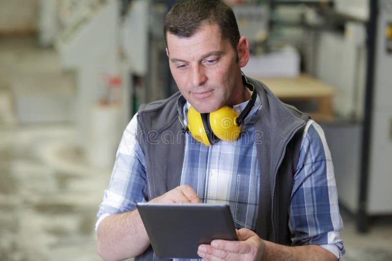 Standing Worker Holding Digital Tablet in Warehouse Stock Photo - Image ...