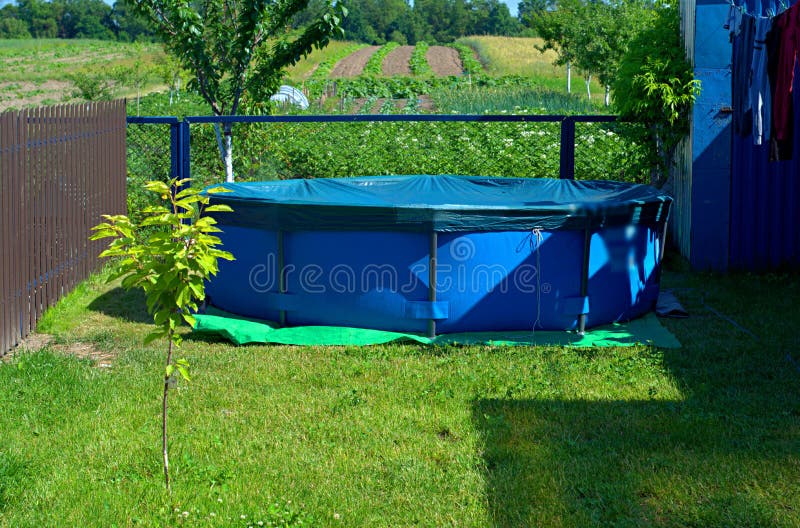 Standing in the Yard is a Blue Frame Pool Stock Photo - Image of pool ...