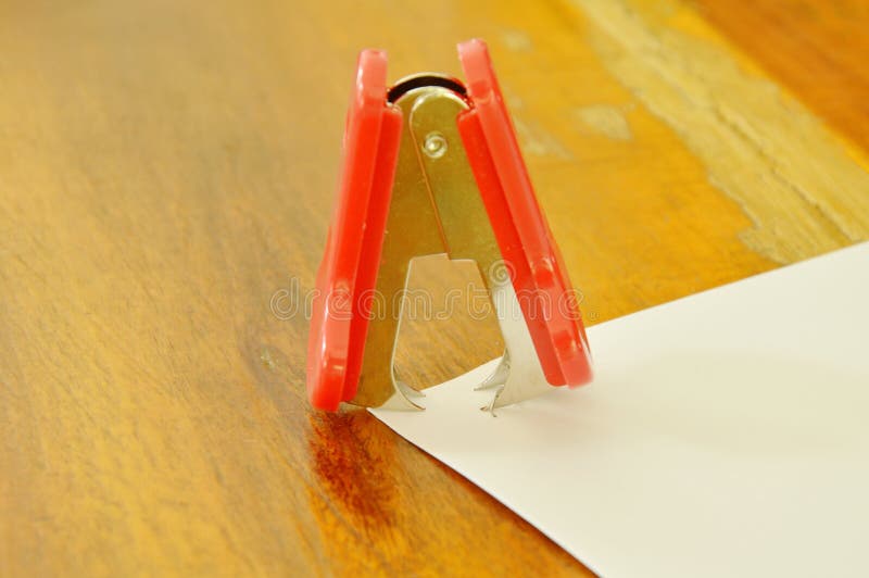 Staple Remover Pulling Wire from Paper on Wooden Table Stock Photo ...