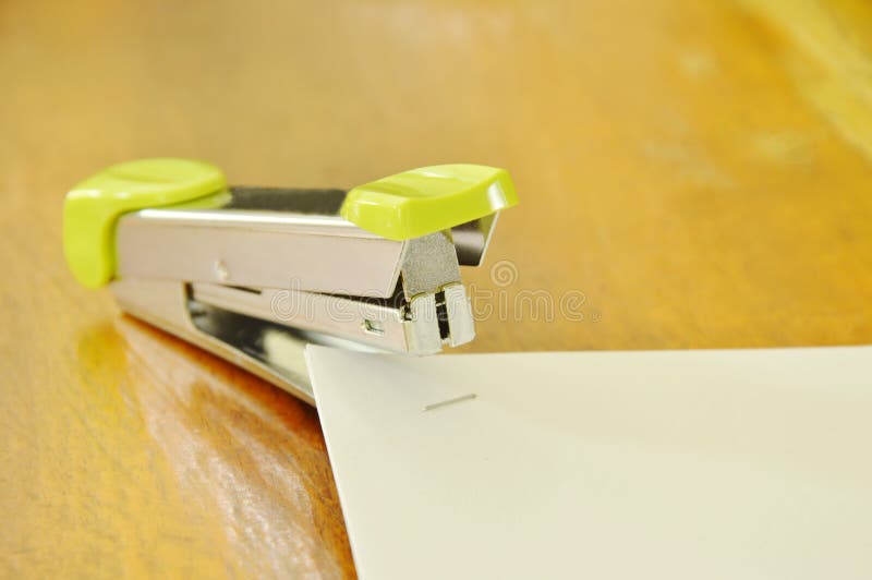 Stapler Pushing White Paper on Wooden Table Stock Photo - Image of ...