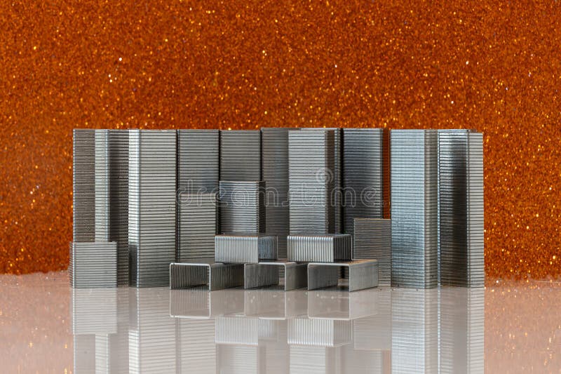 Staples on a Bright Red Glossy Surface Stock Image - Image of clasp ...